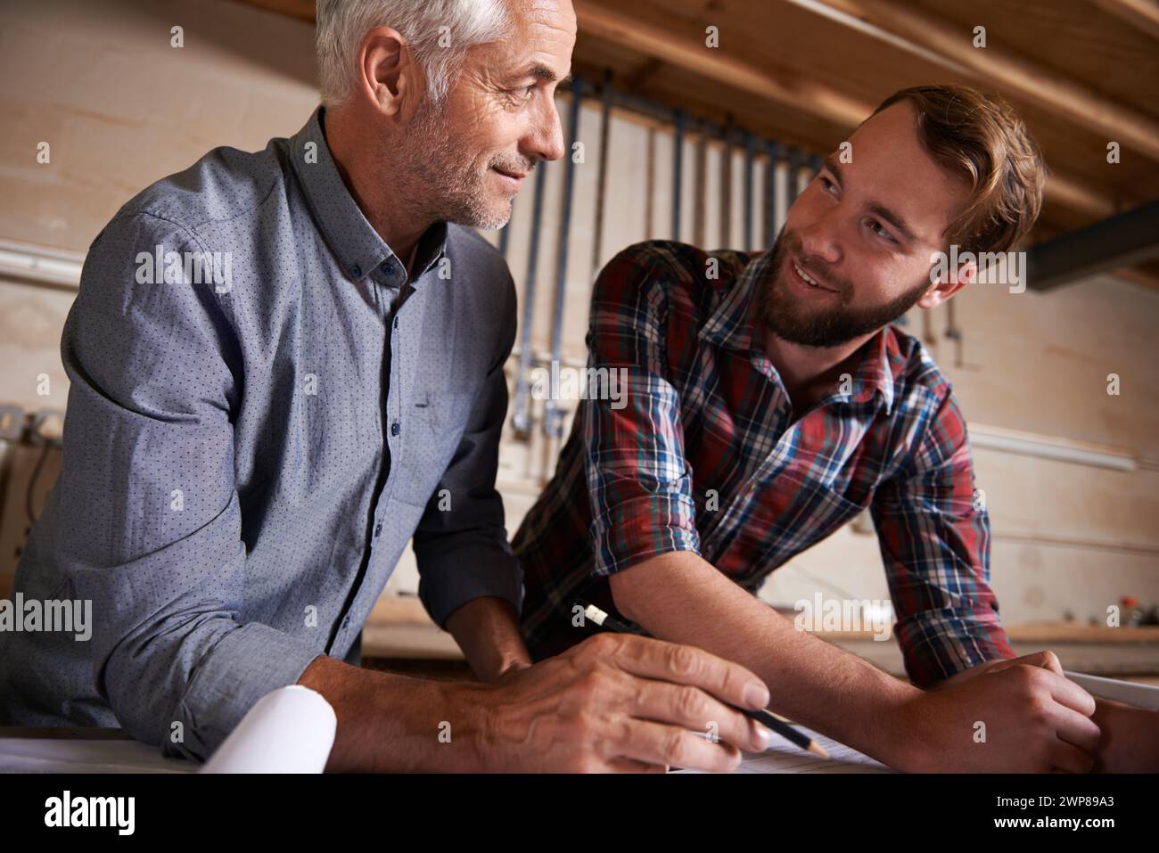 Happy, father and son in a workshop, architect or renovation with ...