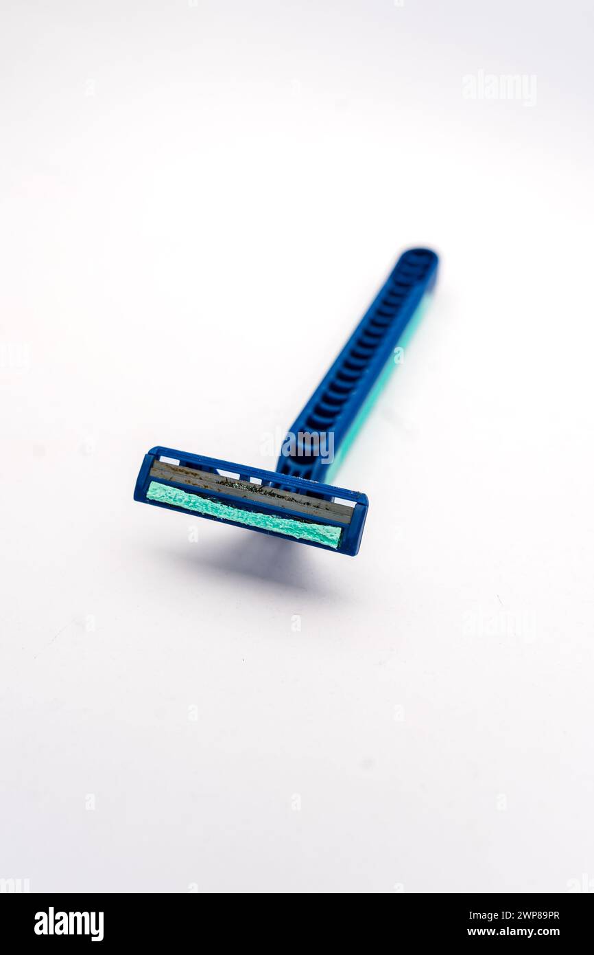 Closeup of used blue disposable razor that is dirty and rusty isolated ...