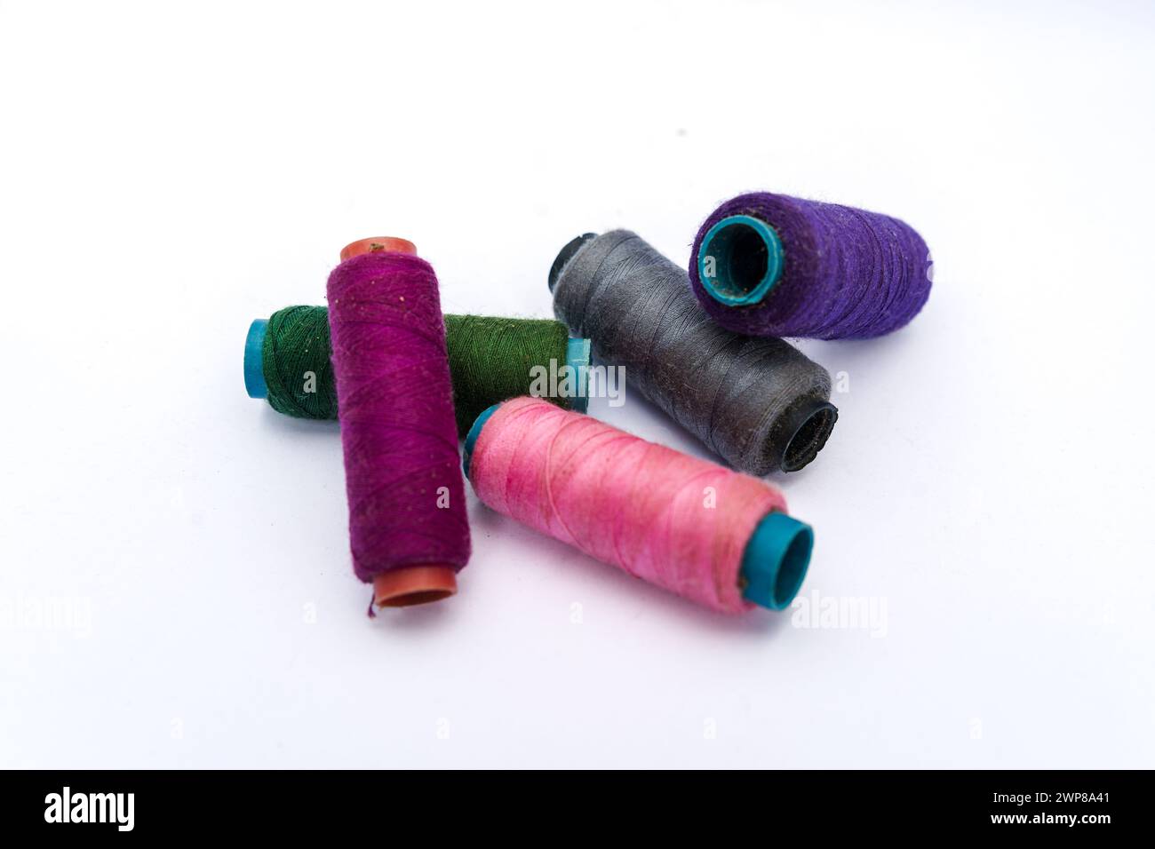 Pile of colorful sewing threads on isolated white background.Colored ...