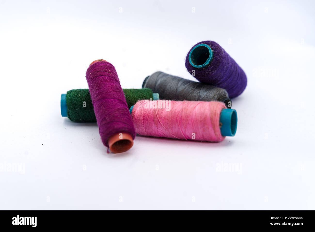 Pile of colorful sewing threads on isolated white background.Colored ...