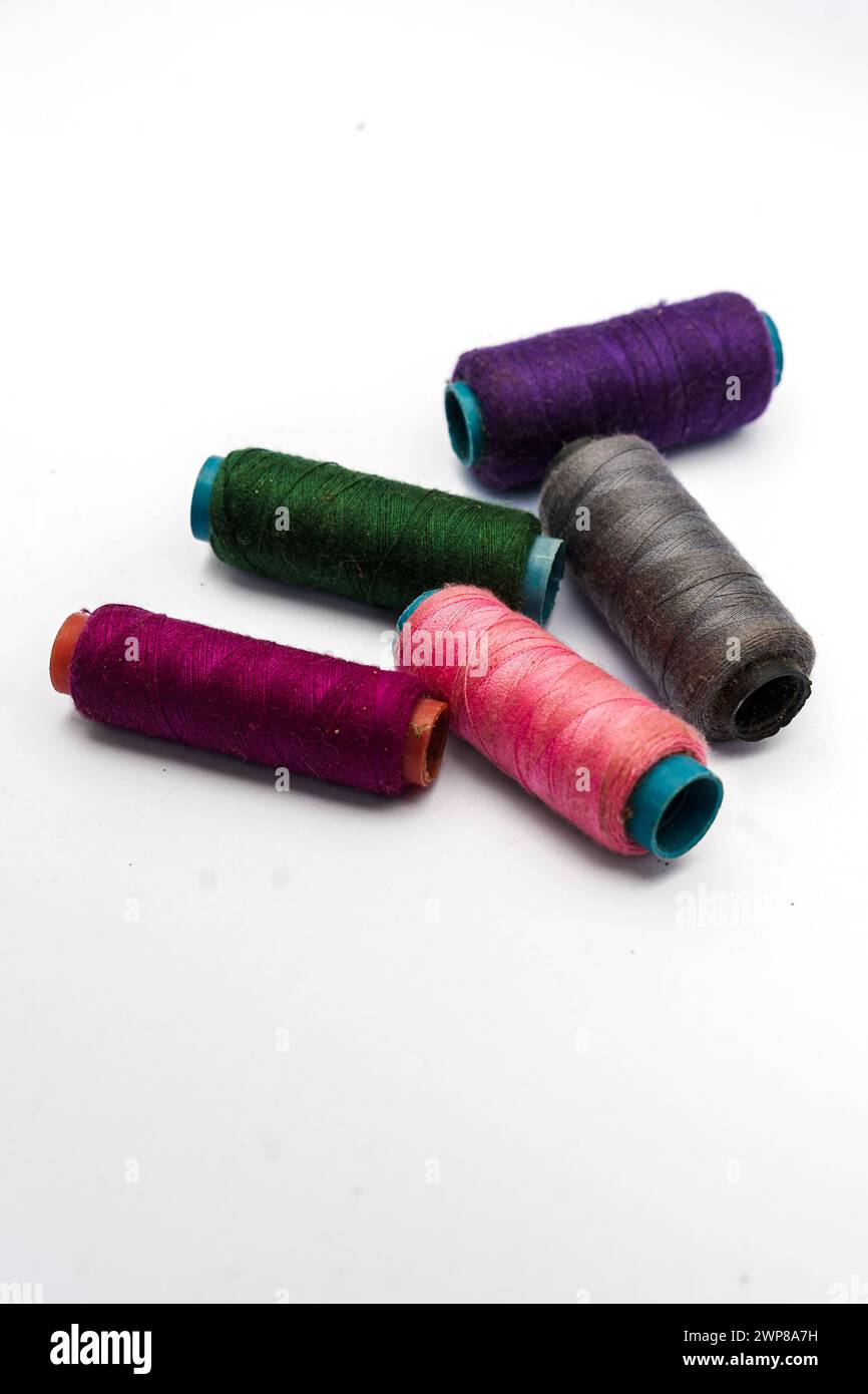 Pile of colorful sewing threads on isolated white background.Colored ...