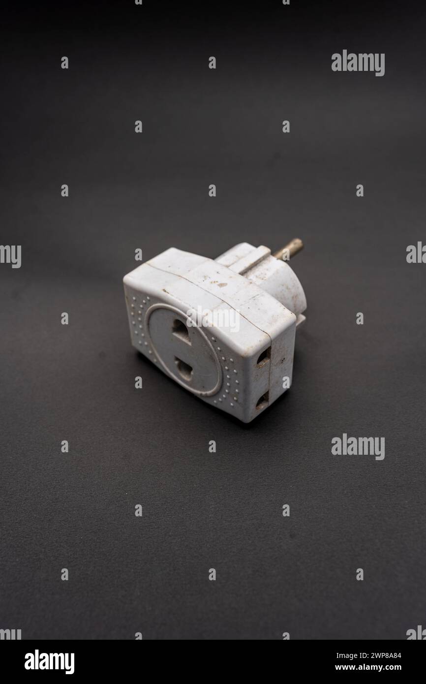 Dirty used triple outlet tap. Electric energy adapter used to split ...