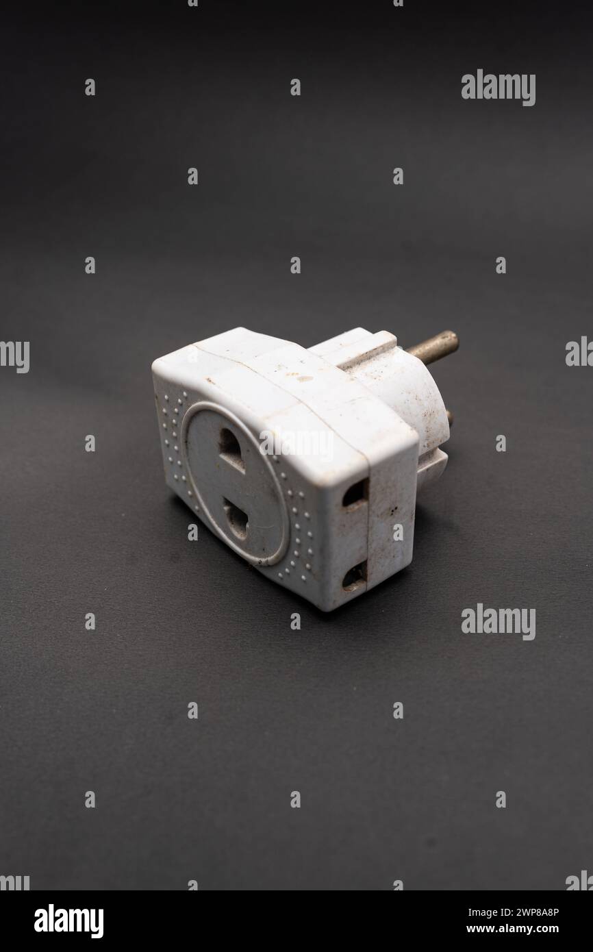 Dirty used triple outlet tap. Electric energy adapter used to split ...