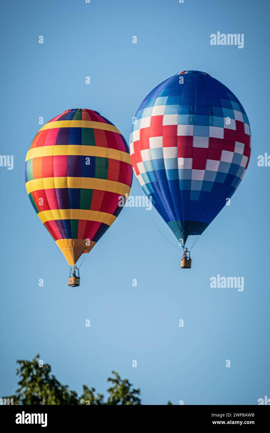 Two vibrant hot air balloons flying together in the sk Stock Photo - Alamy