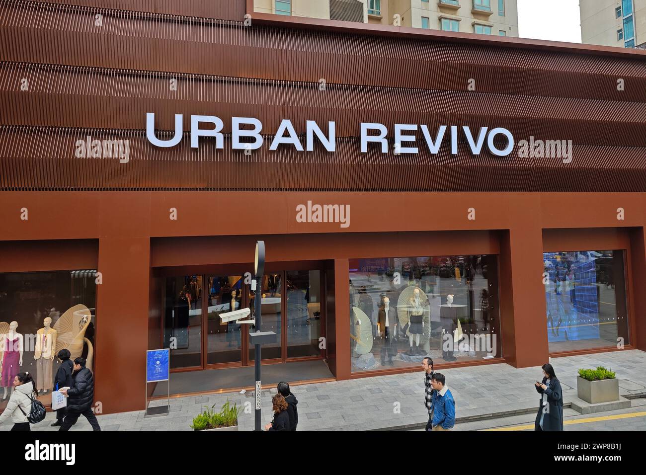 SHANGHAI, CHINA - MARCH 6, 2024 - Visitors walk past the first flagship store of fast fashion ...
