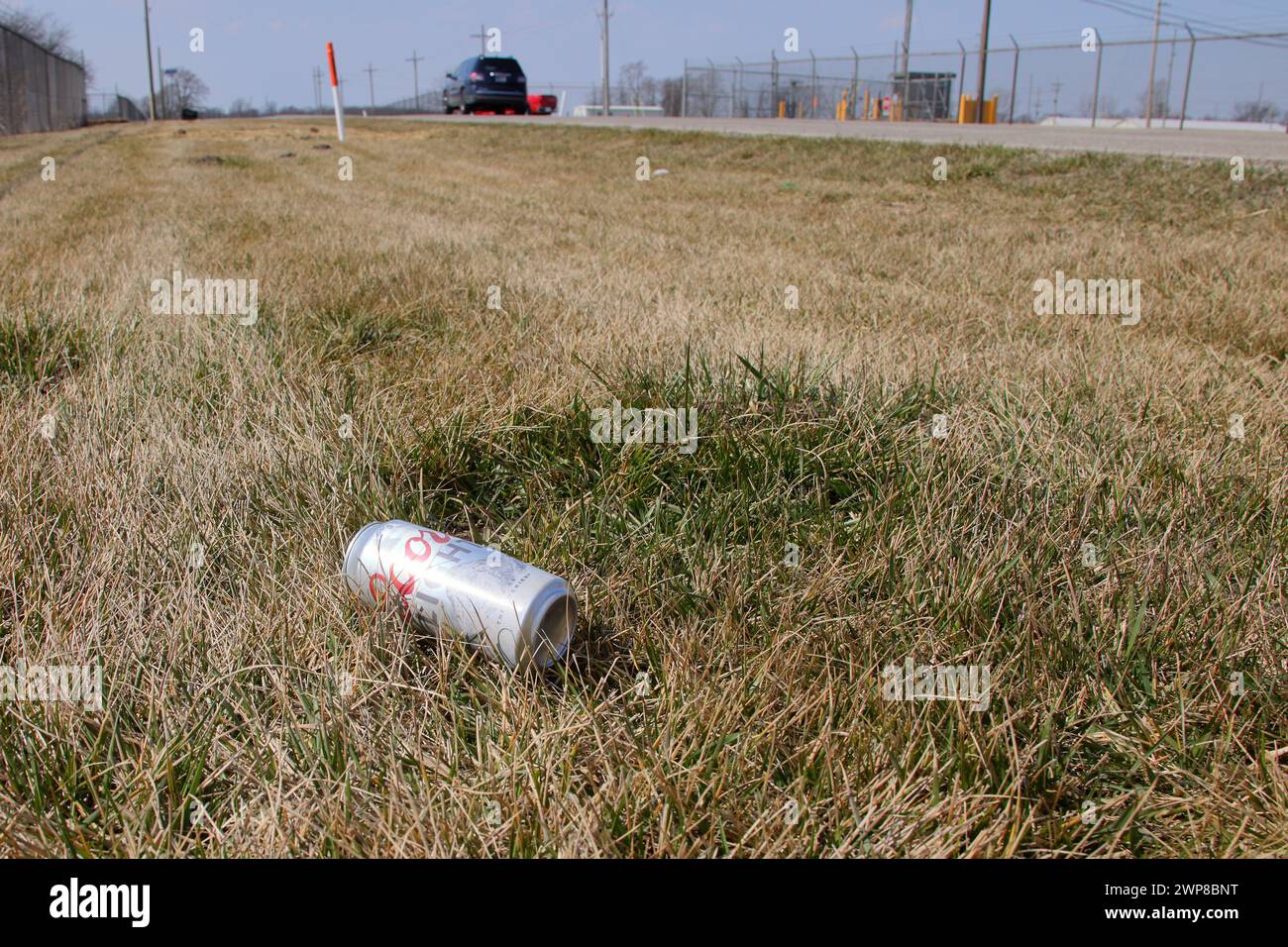 Litter in the grass along a roadside Stock Photo - Alamy