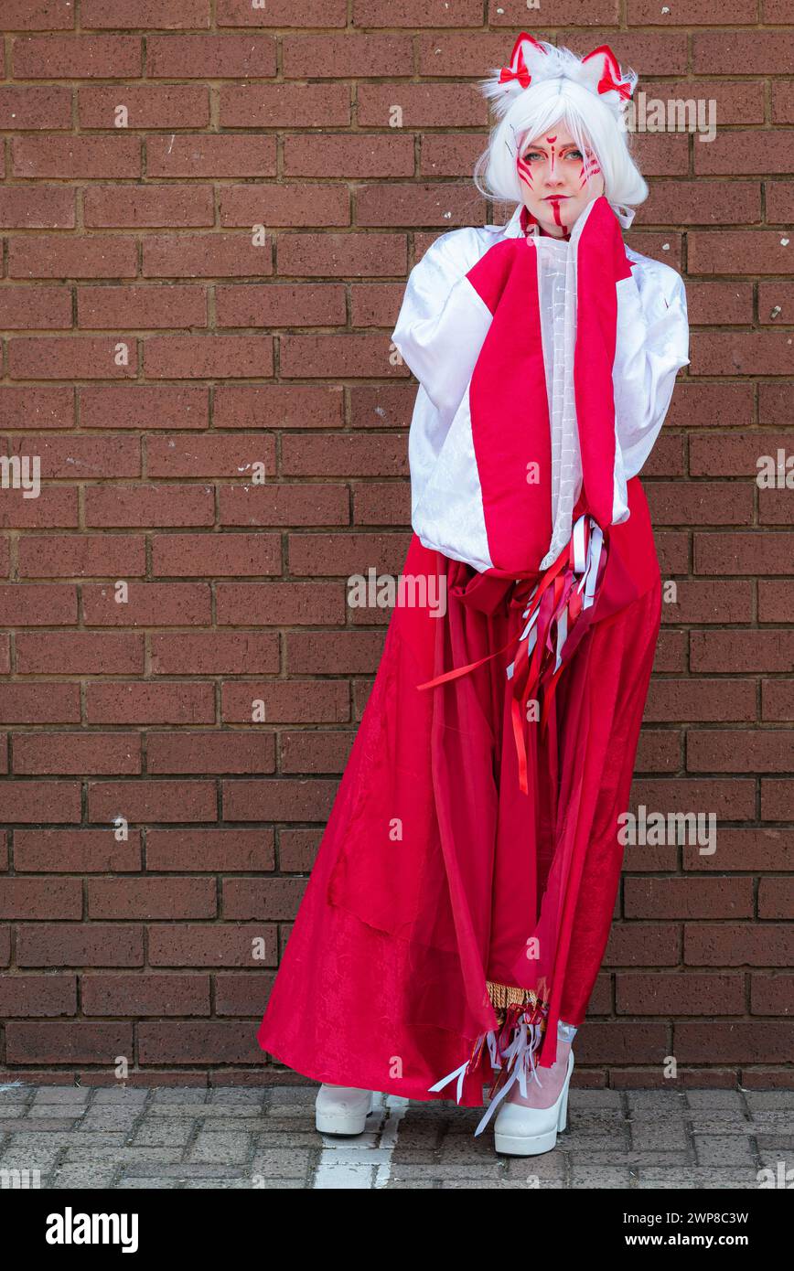 Female cosplayer in feline priestess attire at a convention Stock Photo ...
