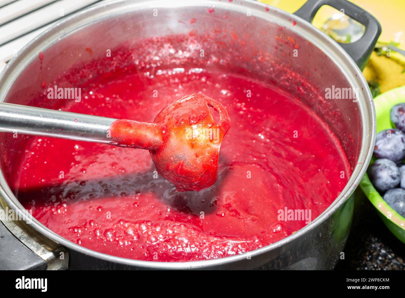 A pan of plum puree, whipped in a blender. Making jam, sweet fruit ...