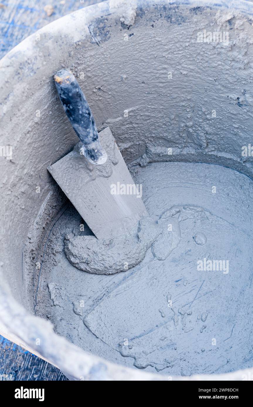 Concrete mixer blending in a cement container using a mixing tool Stock ...