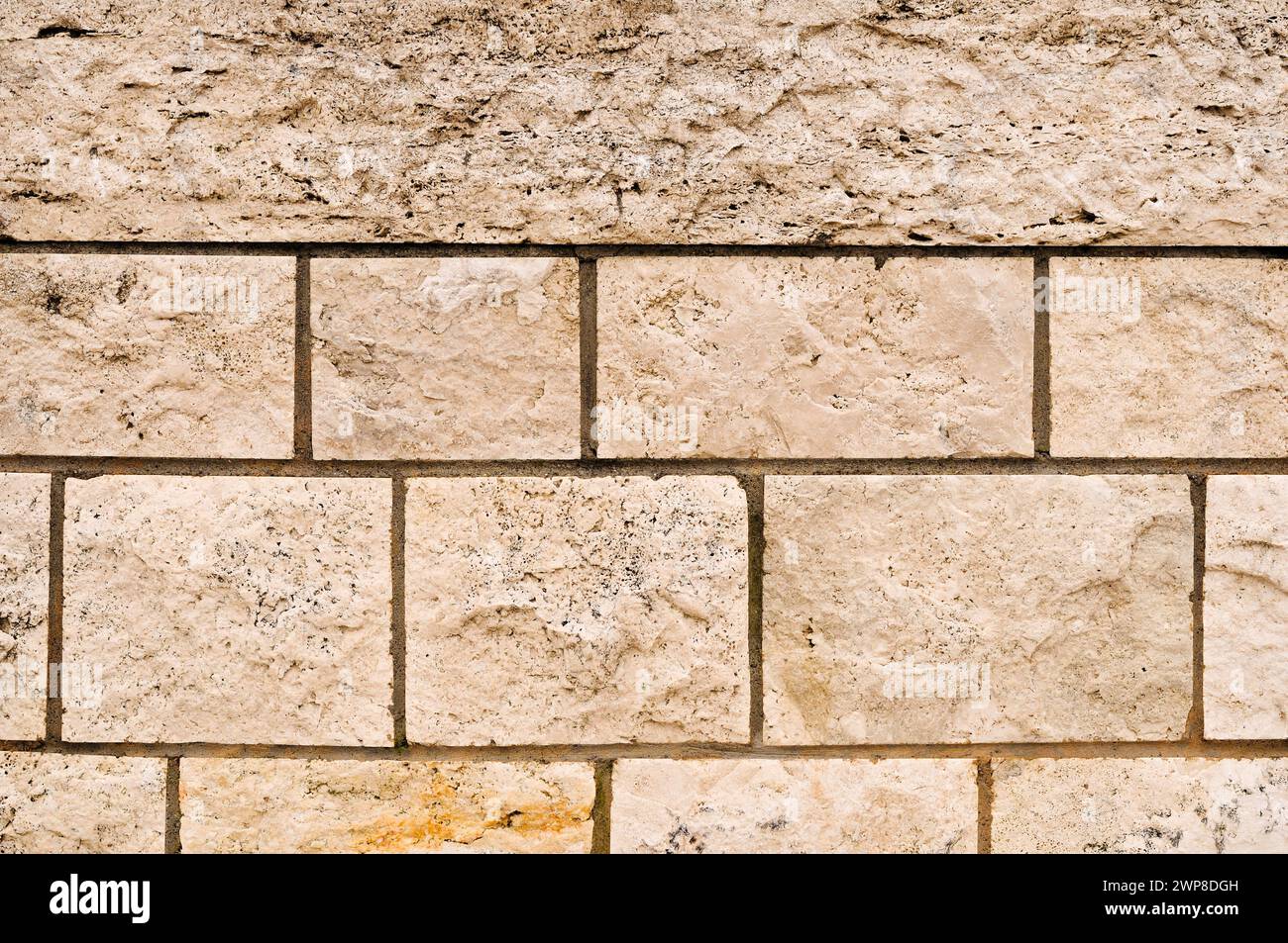 A red fire hydrant stationed next to a building Stock Photo - Alamy