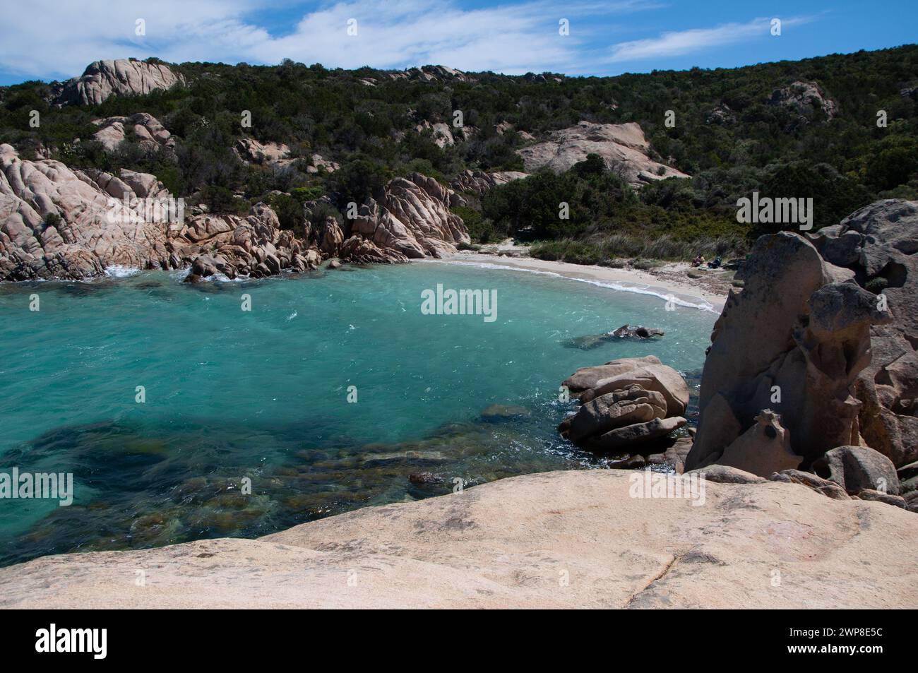 Scenic beach with mountain backdrop and clear blue water Stock Photo ...