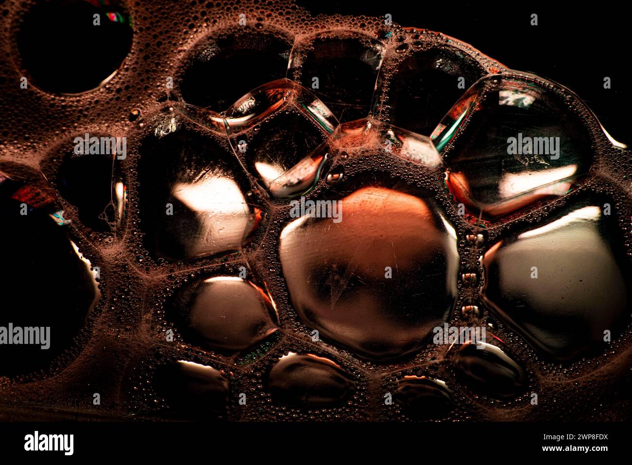 A close-up of bubbles in a sink, with orange and black colors Stock ...