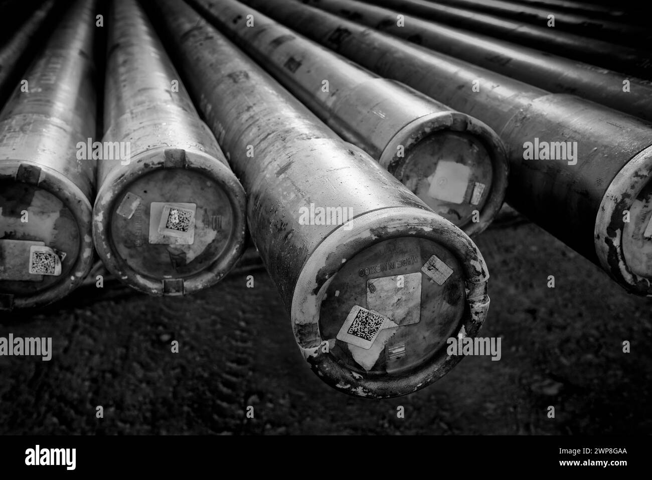 A black and white photograph of drilling pipe for an oil rig Stock ...