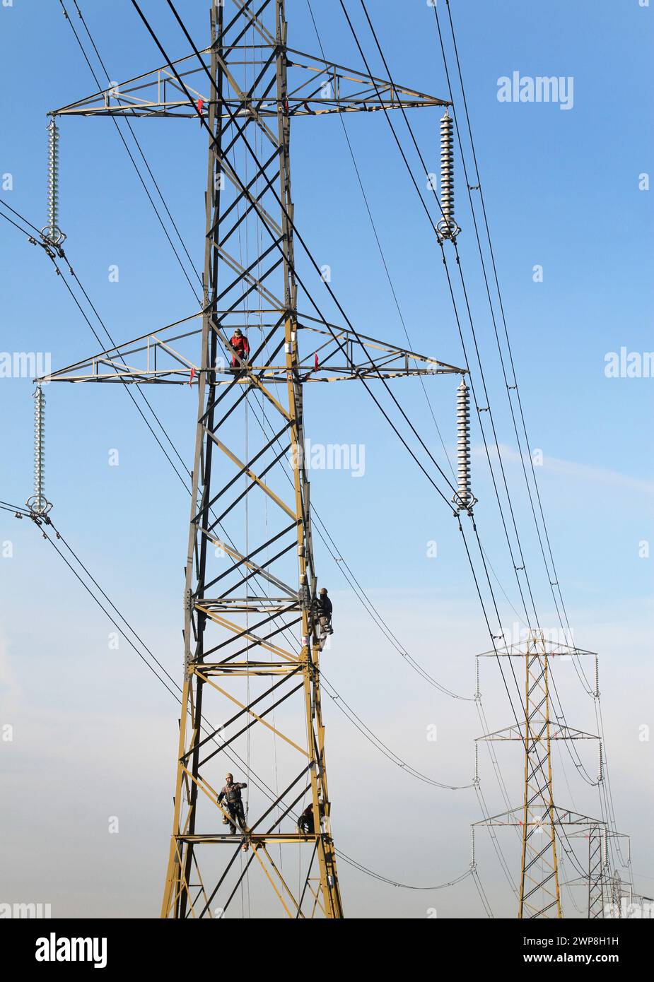 29/11/12 Workmen paint high voltage electricity pylons near Alderley ...