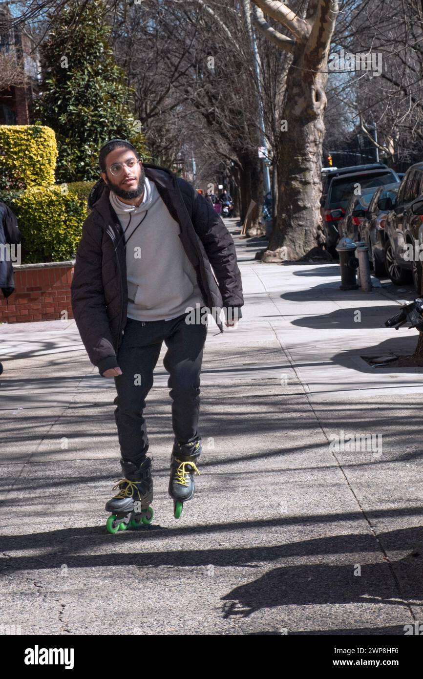 An orthodox Jewish man on roller skating on Crown Street in Crown ...