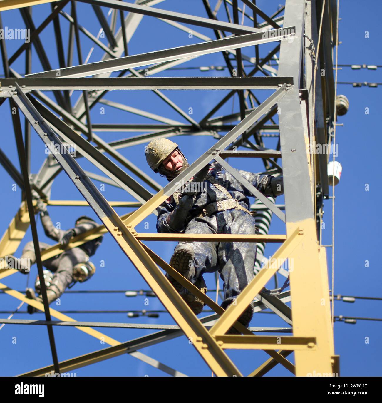 29/11/12 Workmen paint high voltage electricity pylons near Alderley ...