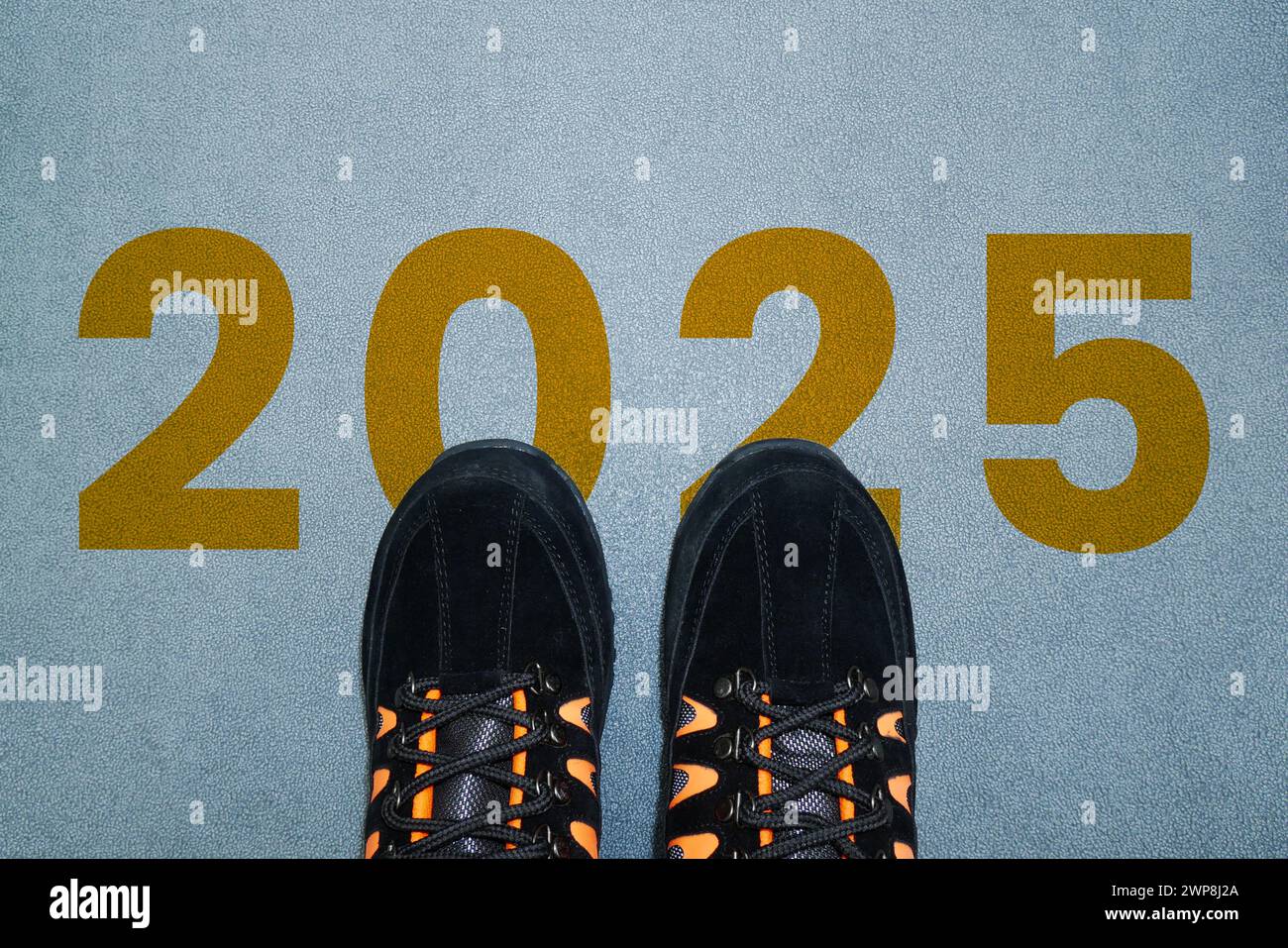 Runners step on the text START, a sign leading to the new year 2025 ...