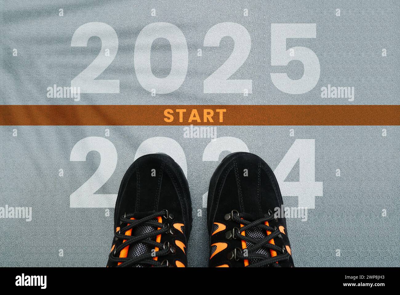 Runners step on the text START, a sign leading to the new year 2025 ...