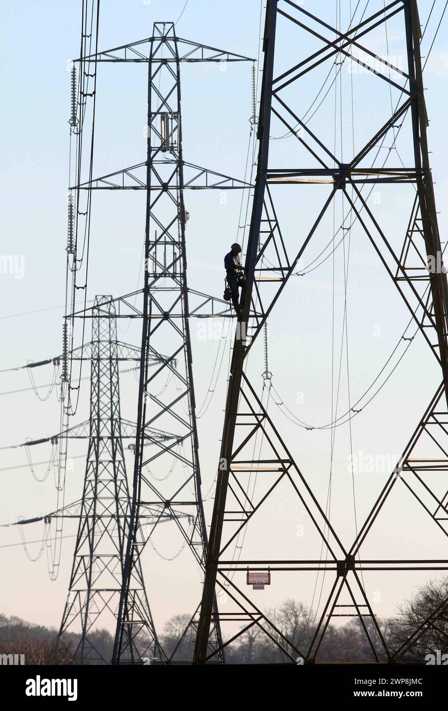 29/11/12 Workmen paint high voltage electricity pylons near Alderley ...