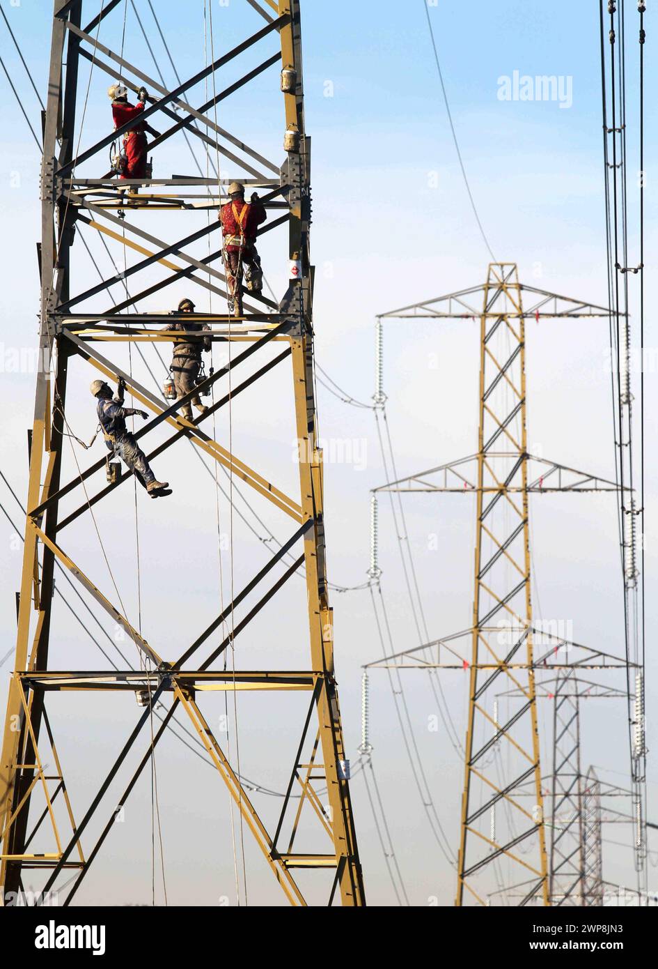 29/11/12 Workmen paint high voltage electricity pylons near Alderley ...