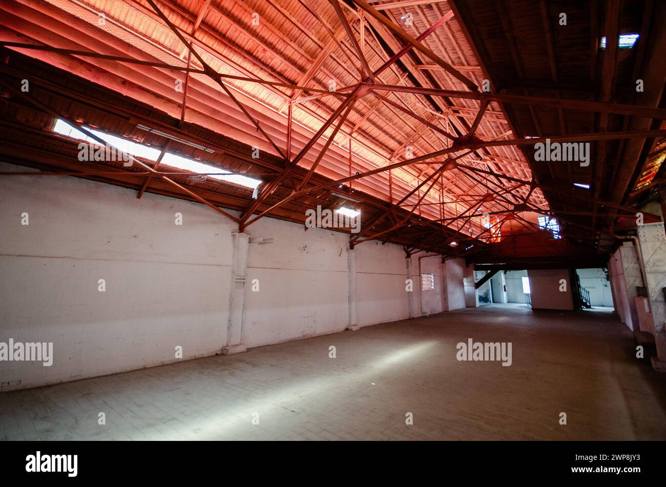 An empty spacious hall with an illuminated ceiling in an old building ...