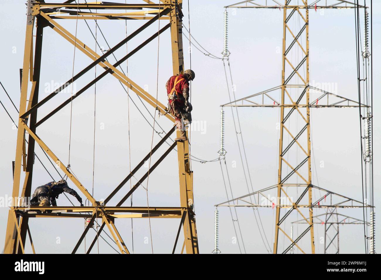 29/11/12 Workmen paint high voltage electricity pylons near Alderley ...