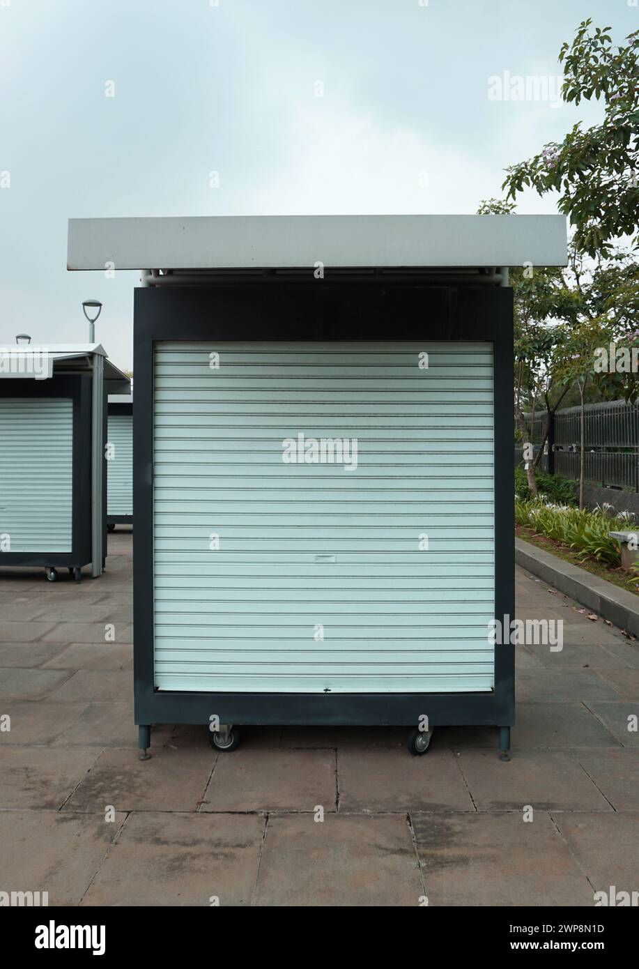The small black container kiosk is equipped with wheels at the bottom ...