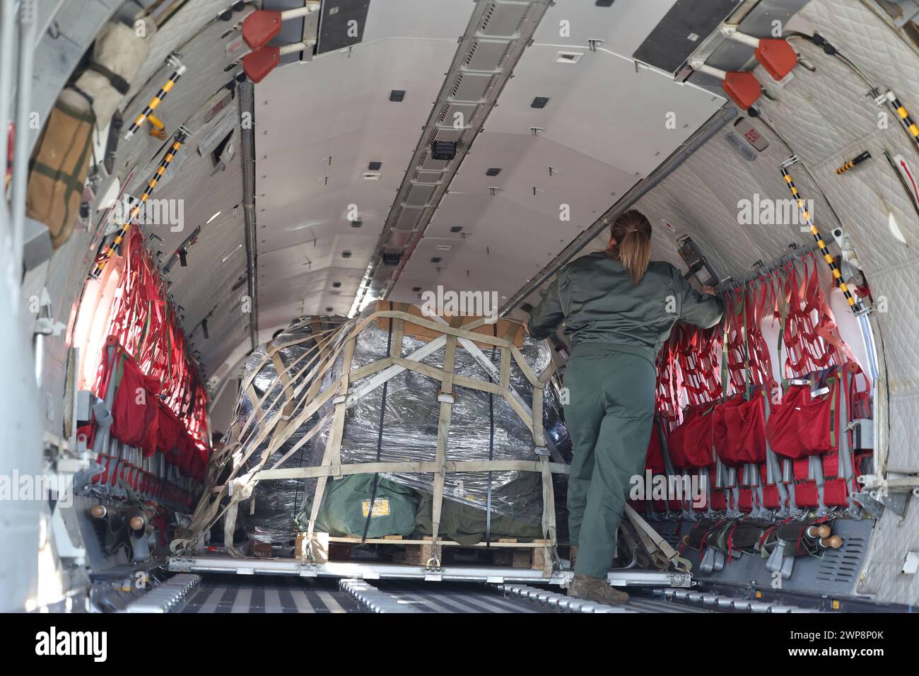 Loading the T21 aircraft with the parachutes that will facilitate ...