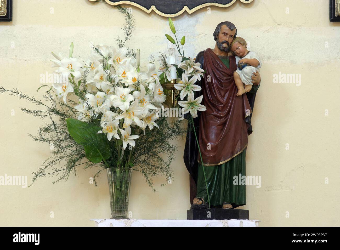 Saint Joseph holding child Jesus, statue in the Parish church of St. Catherine of Alexandria in ...
