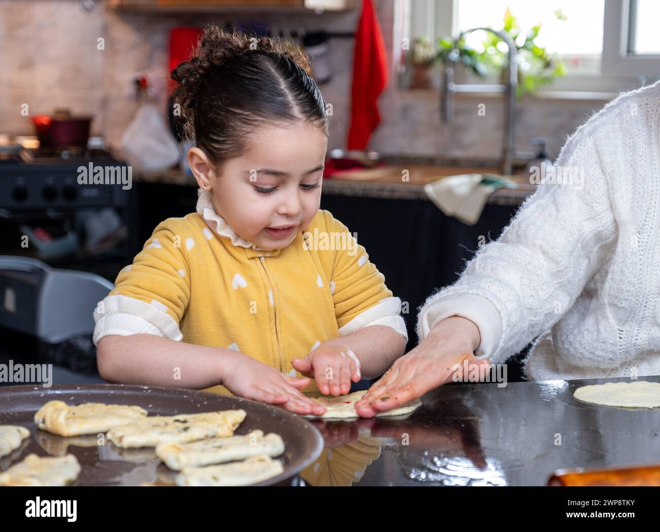 A Heartwarming Scene of Grandmother and Child Bonding in the Kitchen ...
