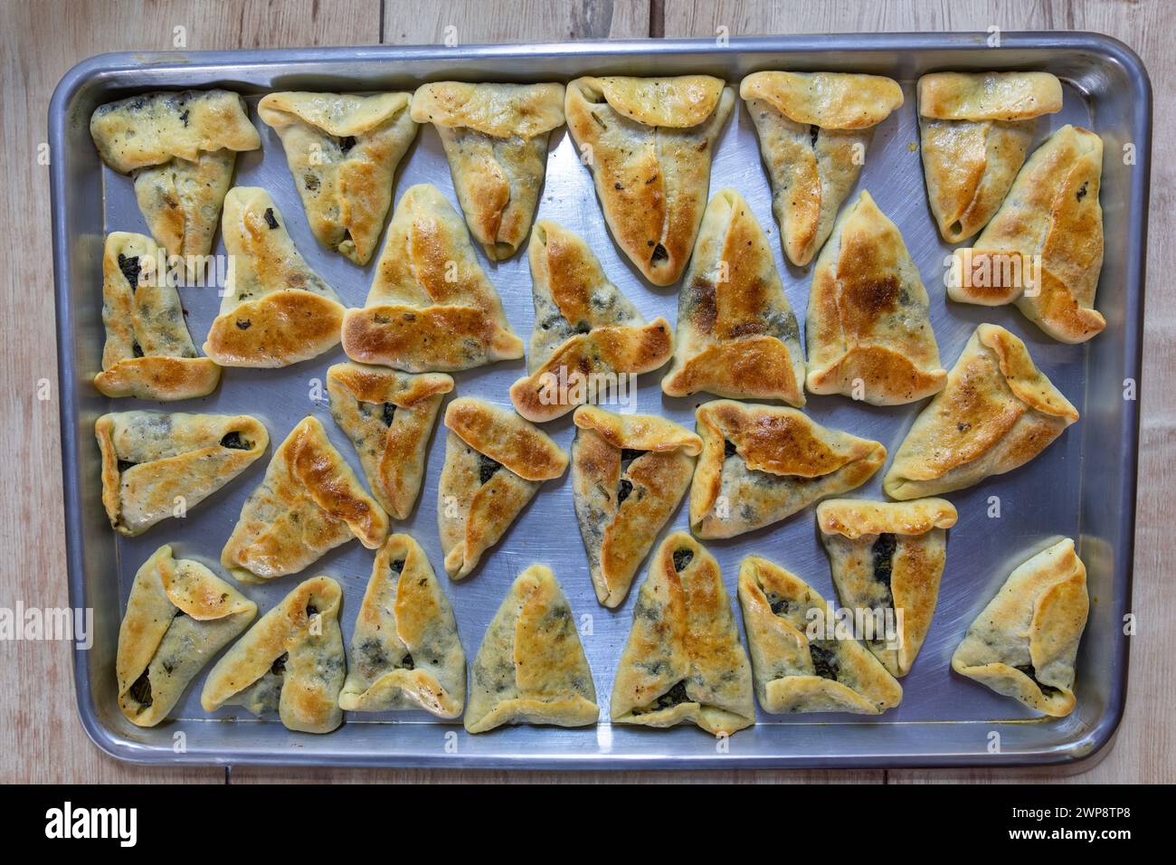 baked stuffed pastries on black marble background ready to be served ...