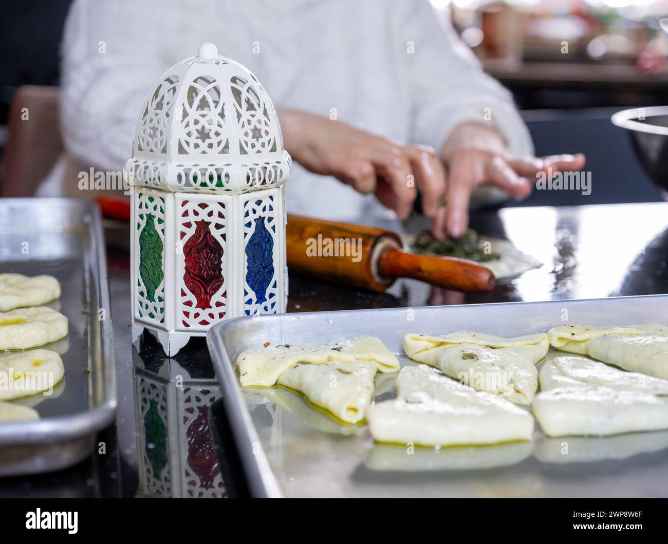 mother preparing food in kitchen during ramadan for her family , famous ...