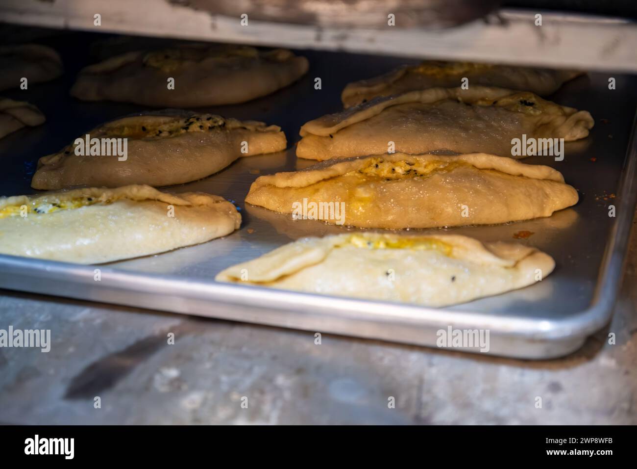 Pastries in oven being baked and freshly made of flour, olive oil and ...