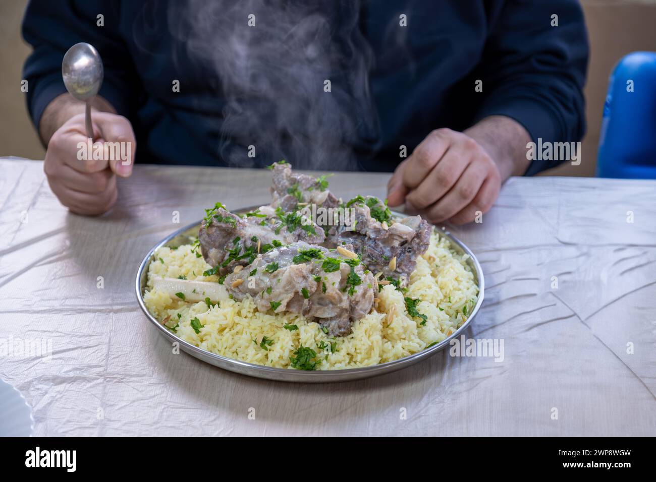 male hands with mansaf from a point of view while preparing his plate ...