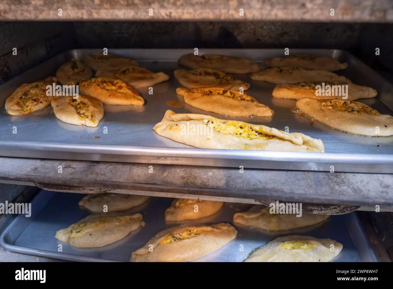 Pastries in oven being baked and freshly made of flour, olive oil and ...