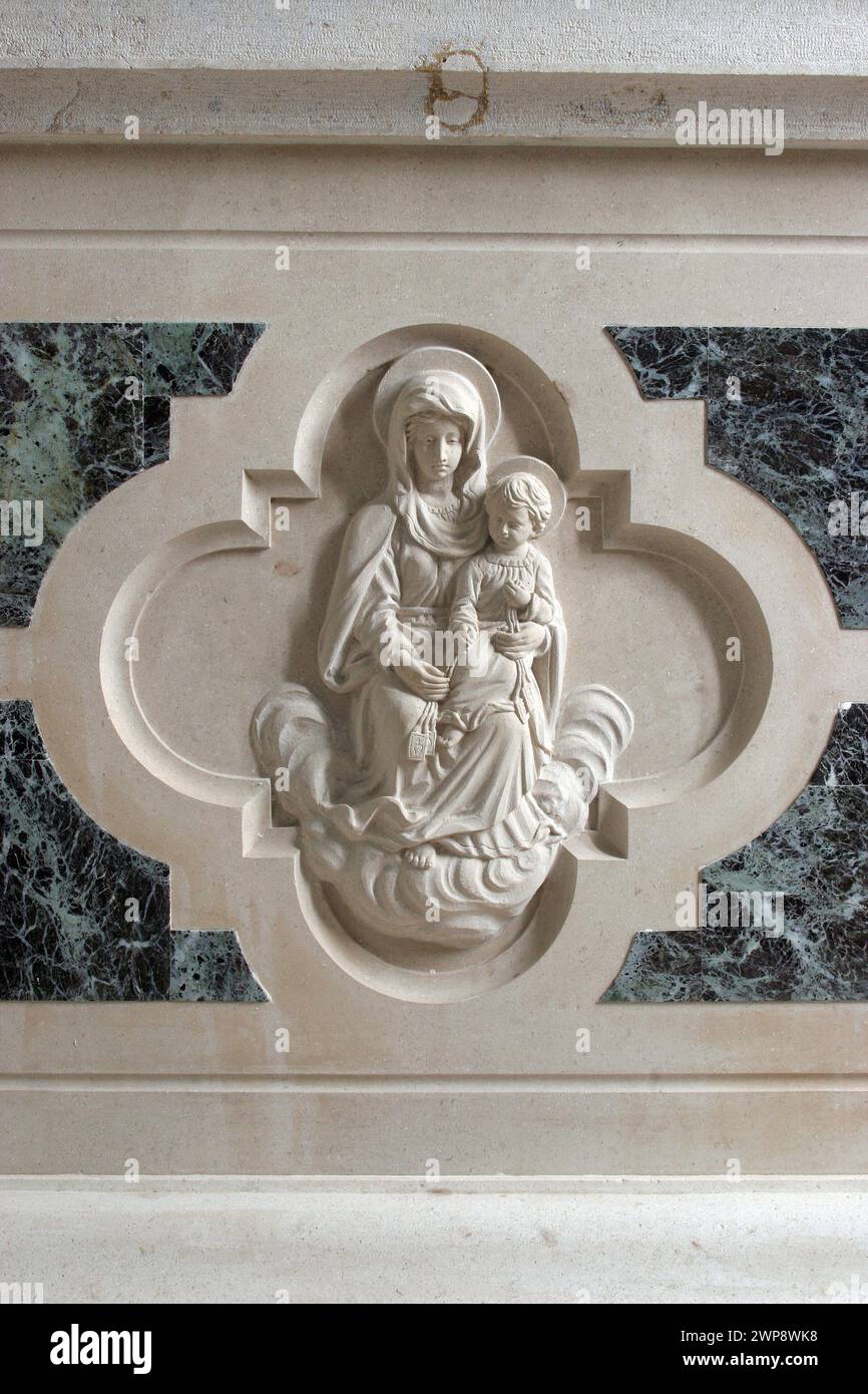 Virgin Mary with baby Jesus, relief on the altar in the Church Our Lady ...