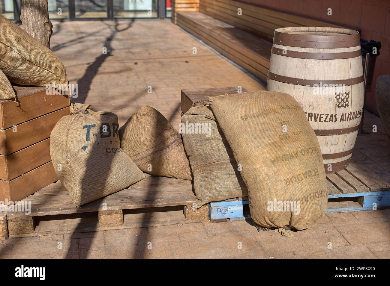 Barcelona, Spain - March 06, 2024: Jute sacks and a wooden barrel on a ...