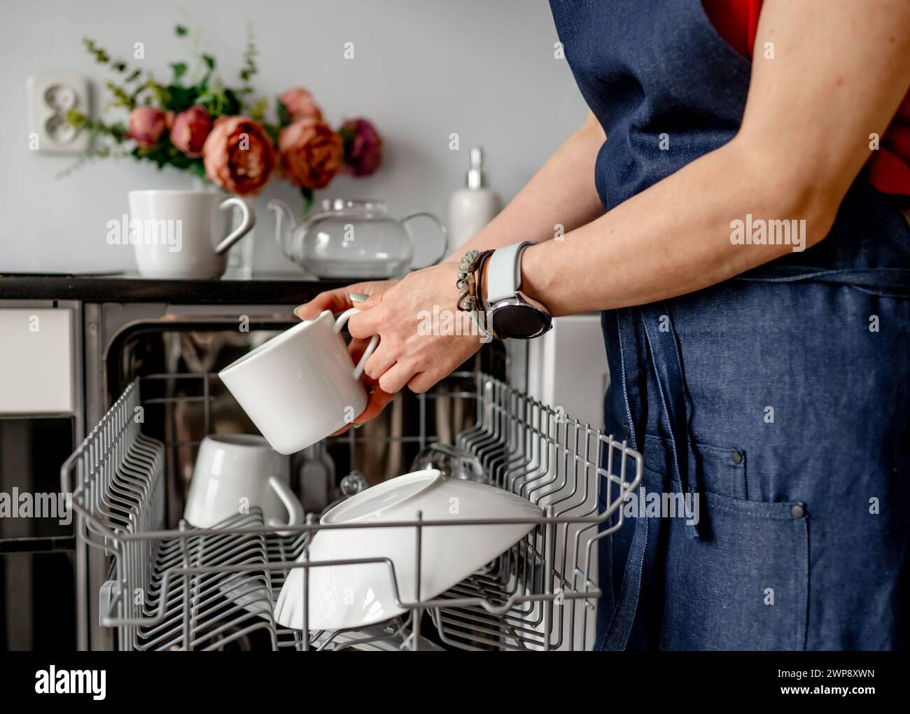 Girl Retrieves Clean Cup From Dishwasher, Clean Dishes Stock Photo - Alamy