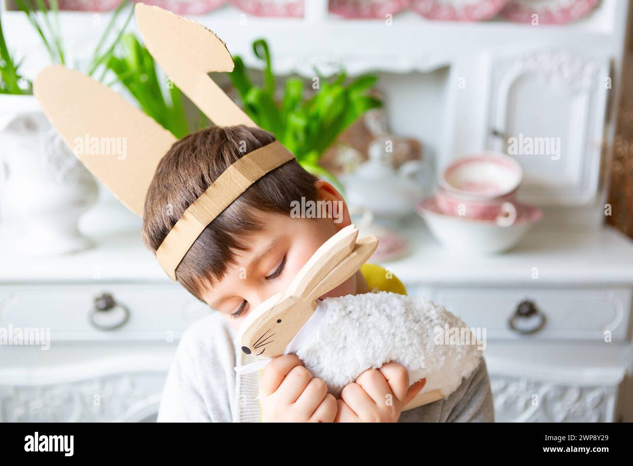 3 March 2024: Little boy is delighted with a wooden Easter bunny. Gift ...