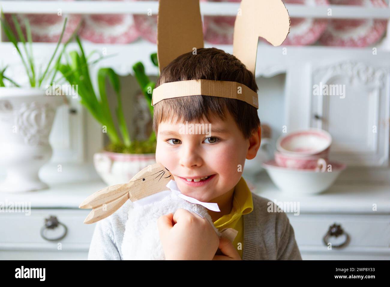 3 March 2024: Little boy is delighted with a wooden Easter bunny. Gift ...