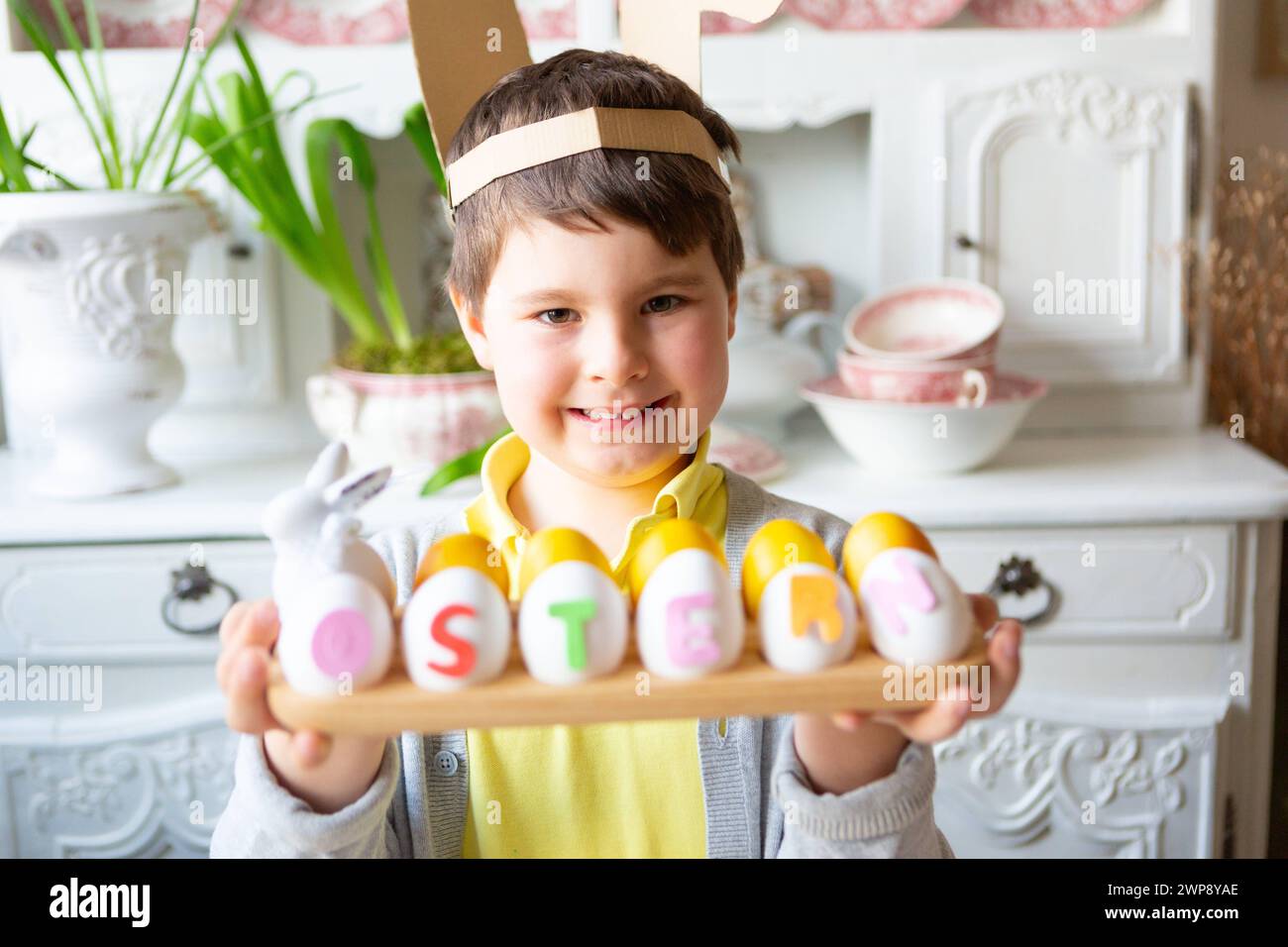 3 March 2024: Little boy making an Easter decoration. Child with bunny ...