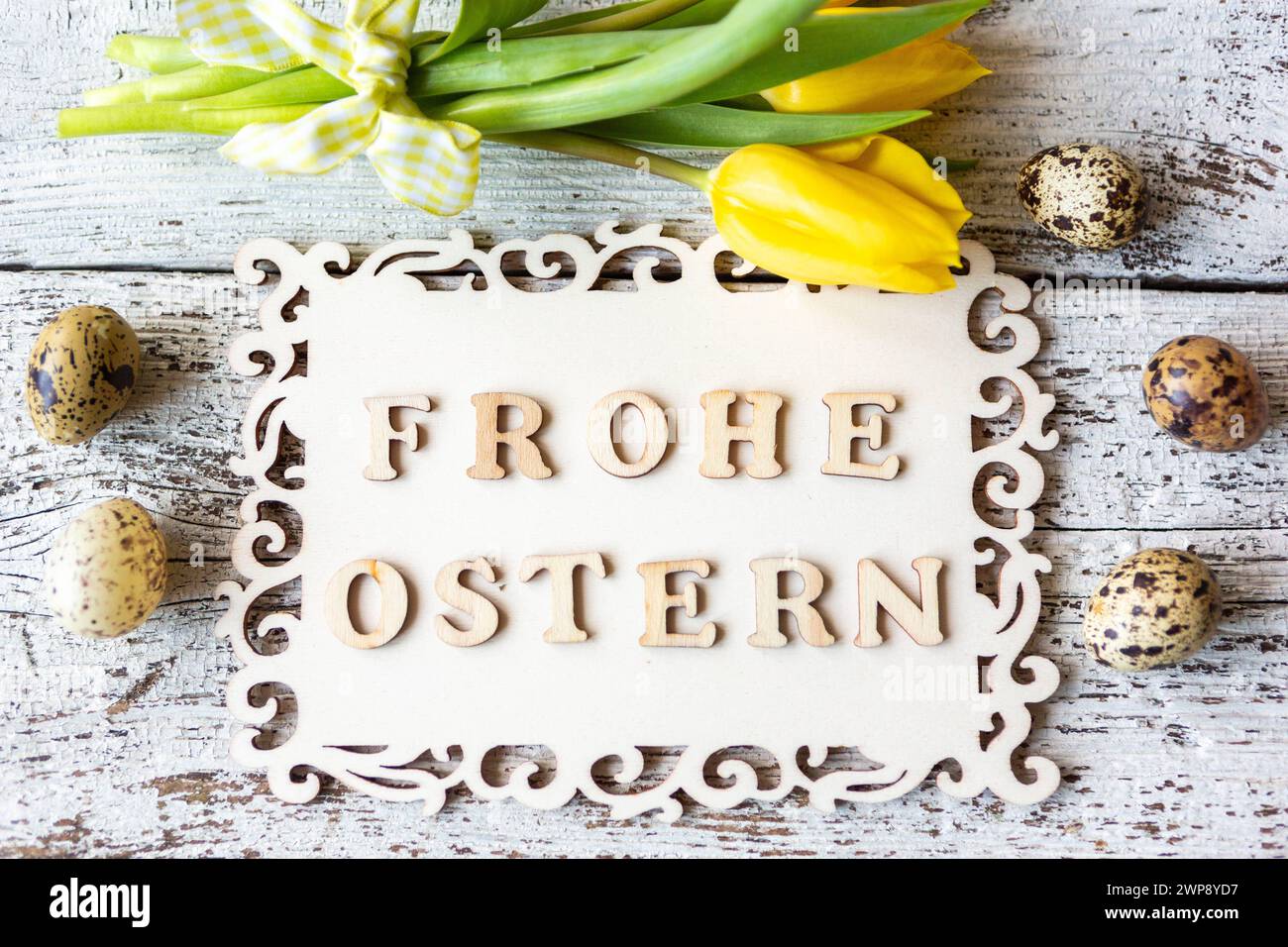 3 March 2024: Happy Easter, greeting on a wooden sign surrounded by ...