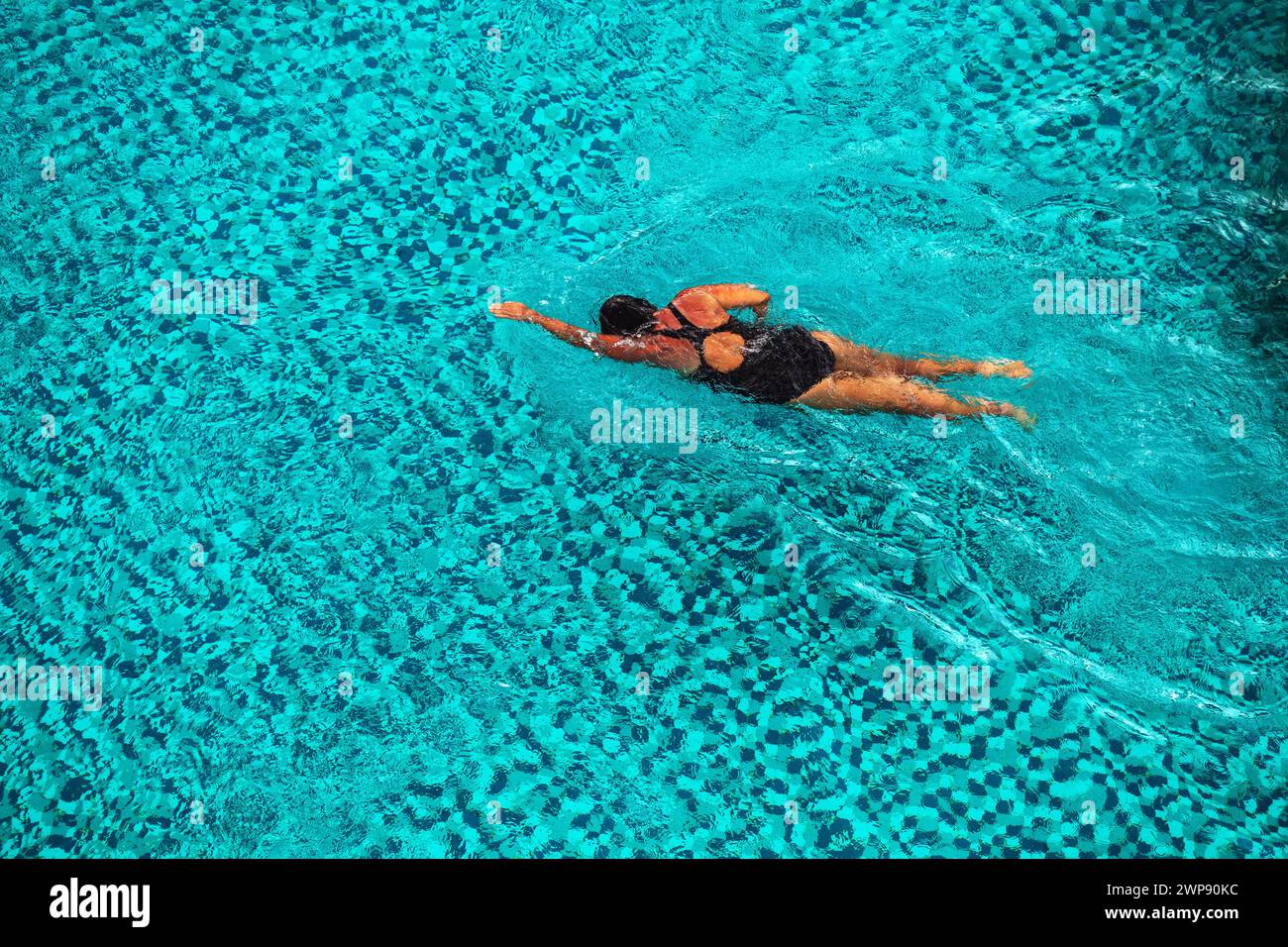 Young woman swimming in outdoor swimming pool on a sunny day Stock ...