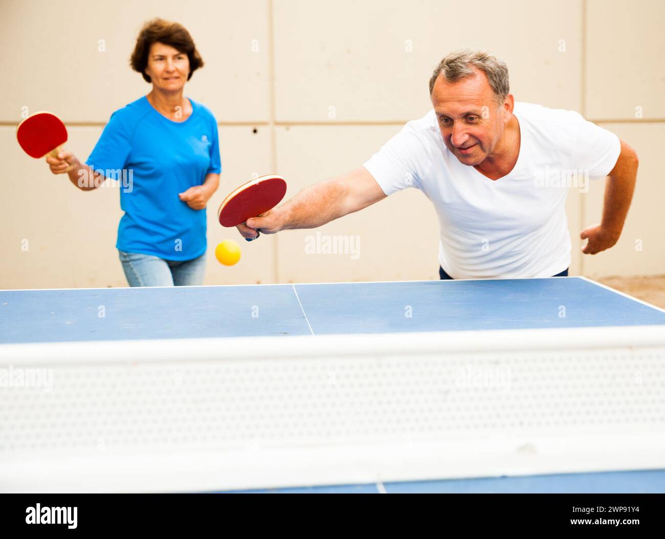 Old couple playing table tennis hi-res stock photography and images - Alamy