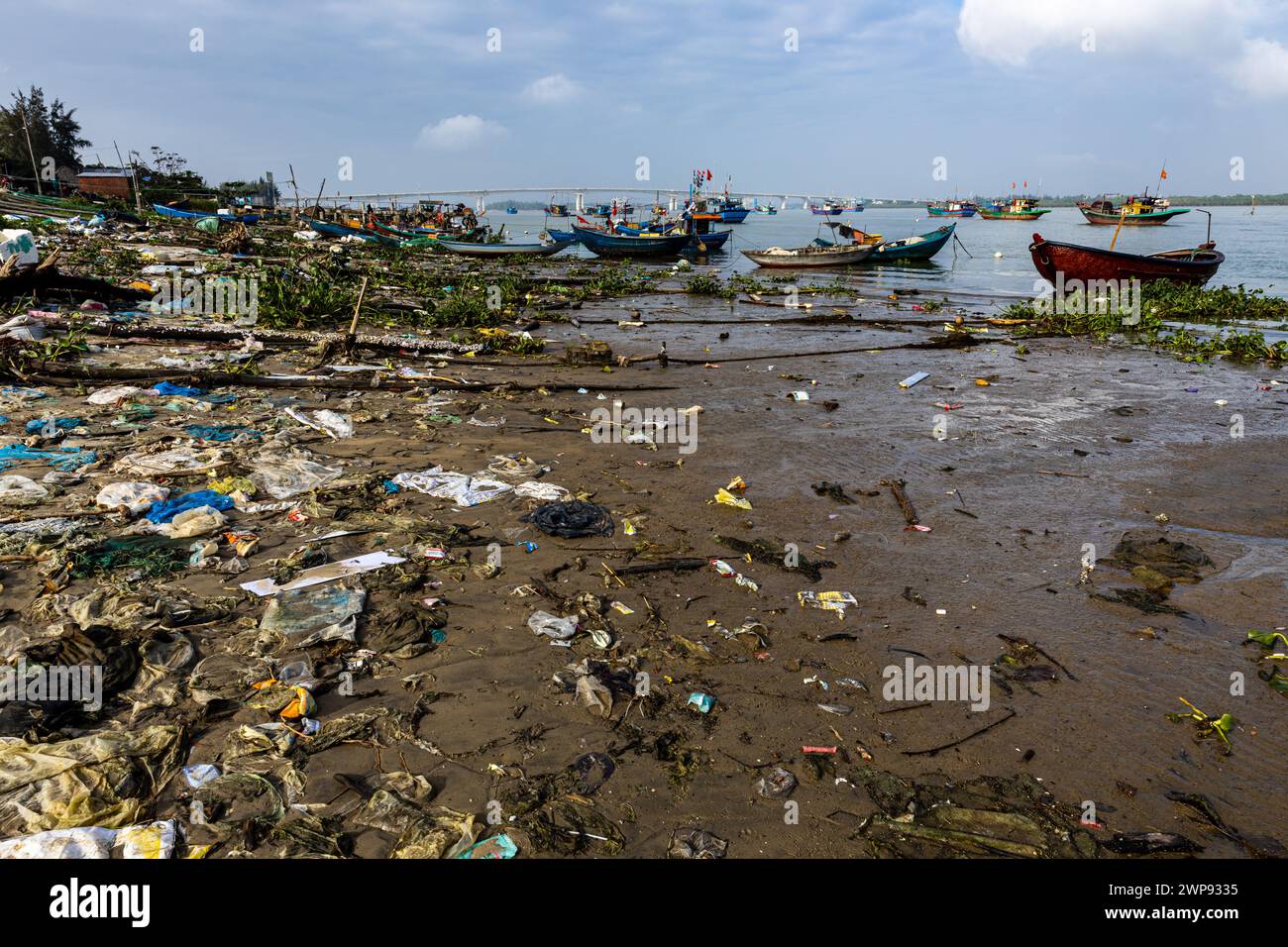 The dirty beach of the fishing harbor of Hoi An in Vietnam Stock Photo ...
