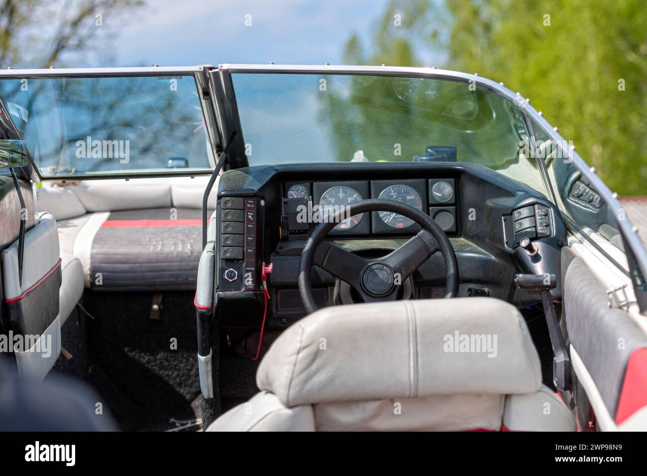 Interior of boat with steering wheel and dashboard Stock Photo - Alamy