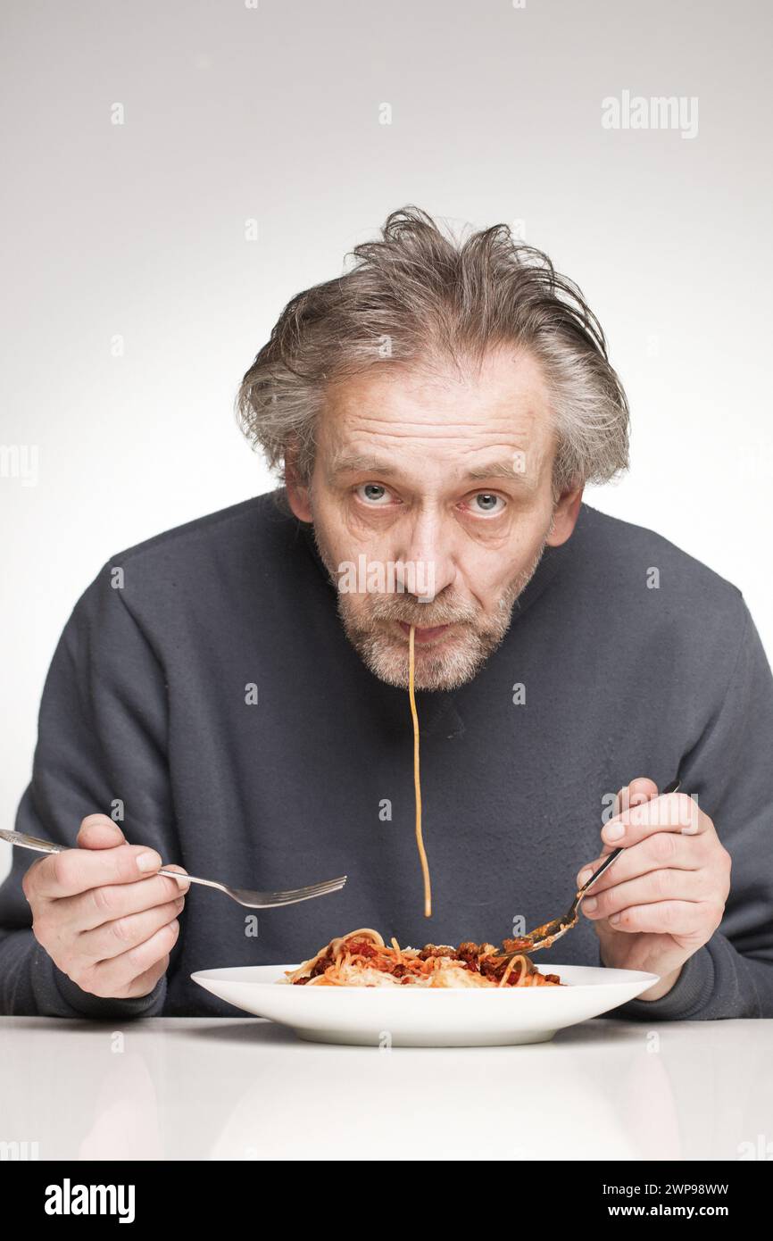 Man eating spaghetti hi-res stock photography and images - Alamy