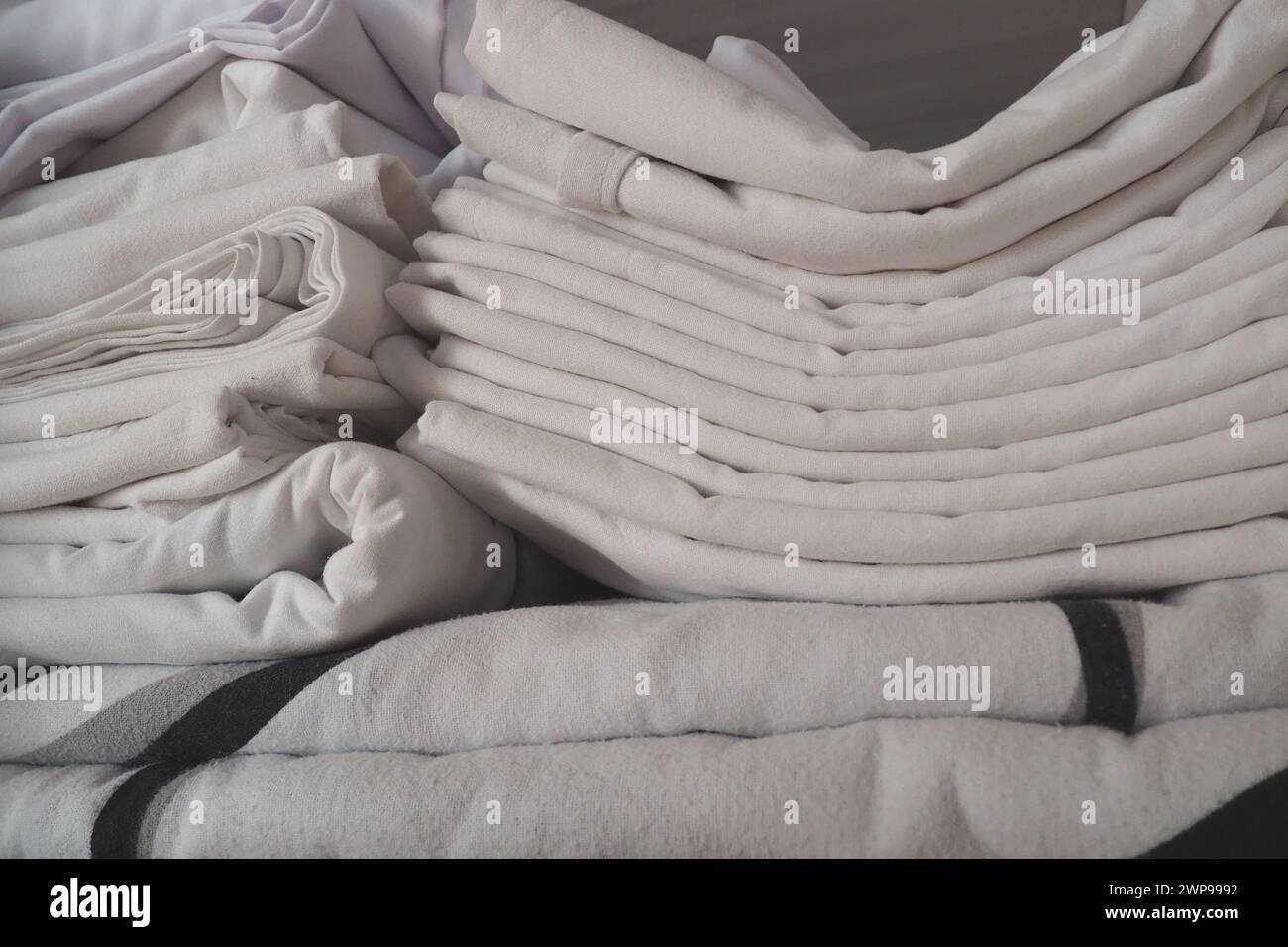 The white linens are stacked in the closet. Internal contents of a ...