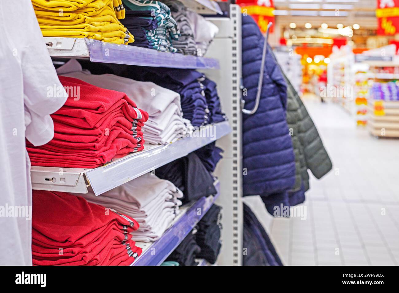 multi-colored men's T-shirts and raglans in the supermarket. Fashion ...