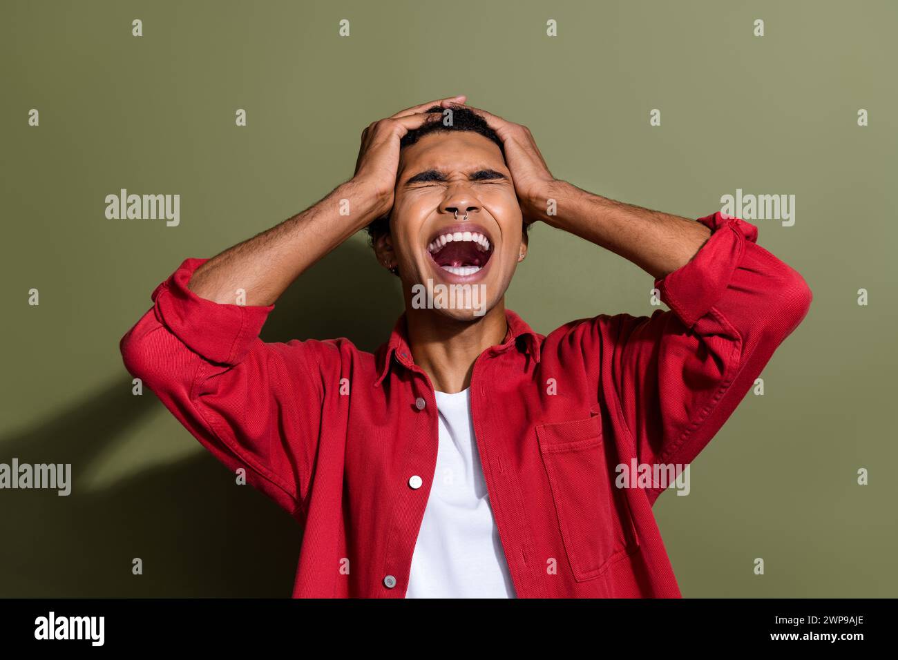Photo of crying mad guy wear red shirt arms head shouting feeling ...